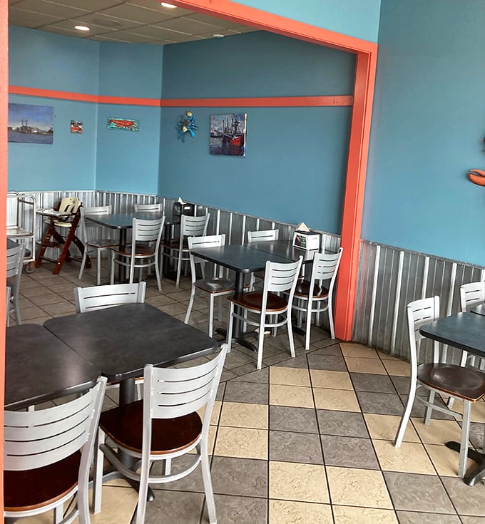 Blue walls, white chairs, and corrugated metal wainscoting create a vibe that says, "We're serious about seafood, not décor."