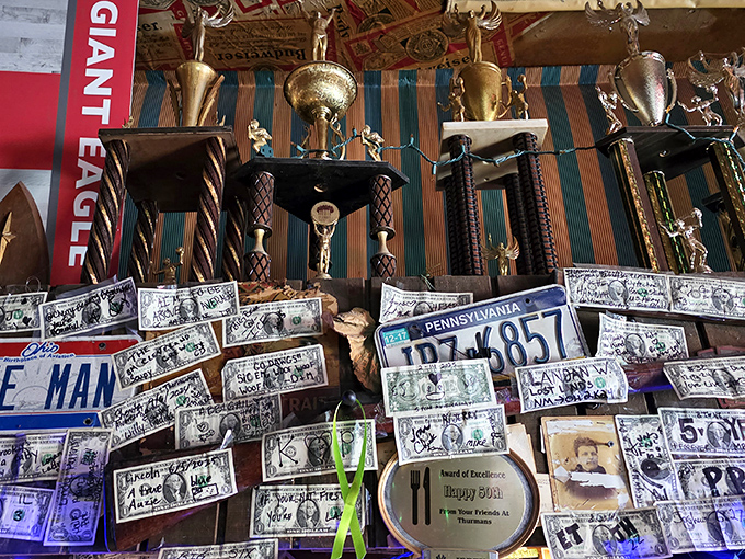 Trophies and dollar bills create a shrine to local achievements and customer appreciation.