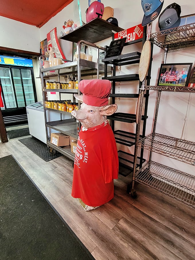 The whimsical pig chef statue stands guard over shelves of Polish provisions—a silent sentinel ensuring traditions remain unbroken and delicious.