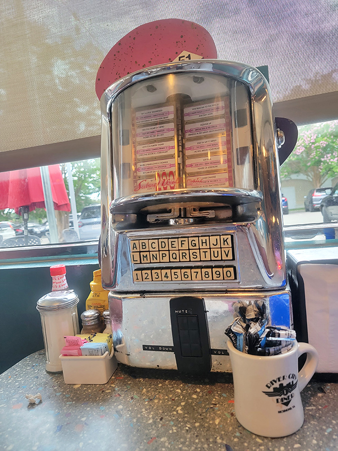 The tabletop jukebox—where five dollars of quarters buys a soundtrack for your meal and memories that last much longer than your appetite.