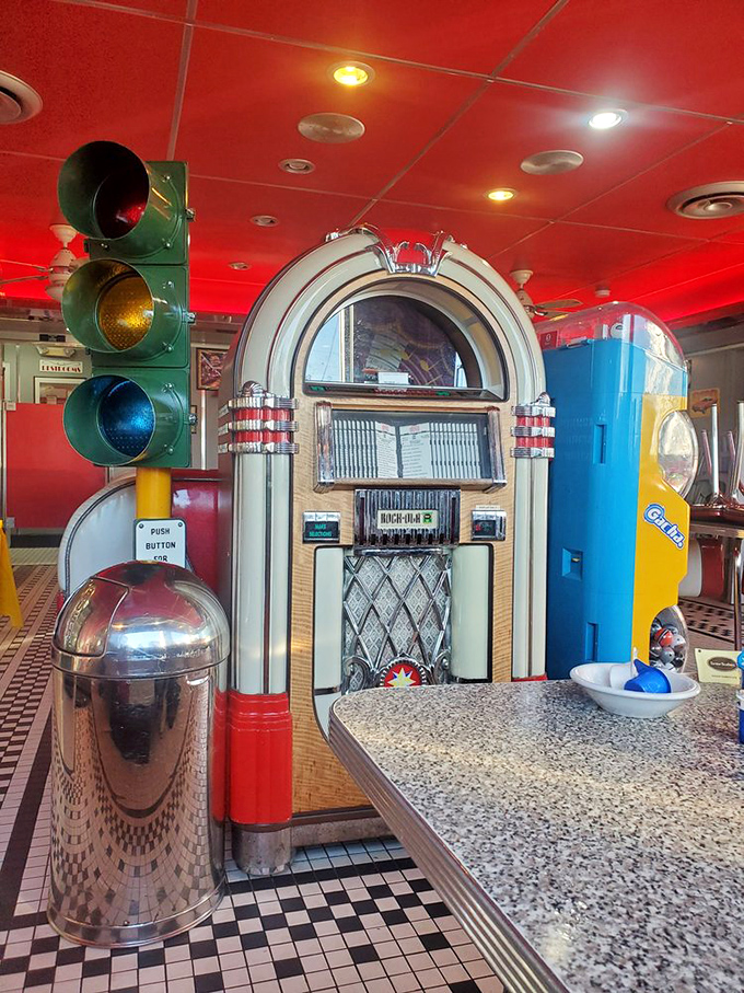 The vintage jukebox and traffic light aren't just decorations – they're time machines that transport you to an era when rock was young and milkshakes ruled.