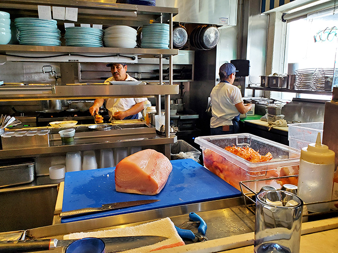 In the open kitchen, chefs transform the ocean's bounty with practiced precision—a delicious performance art that ends on your plate.