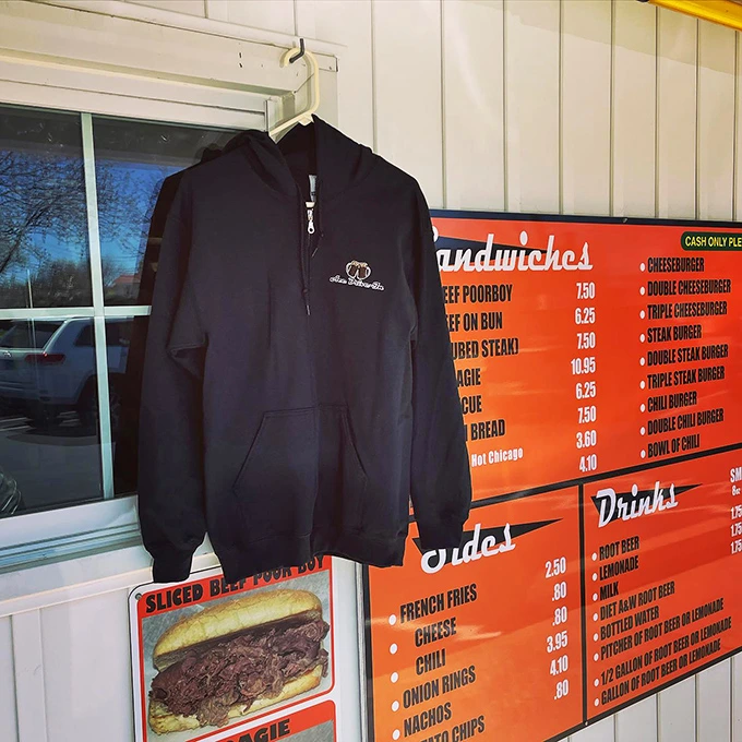 Even the merch is old-school cool—a hoodie hanging by the menu board, because some places are worth wearing your loyalty.