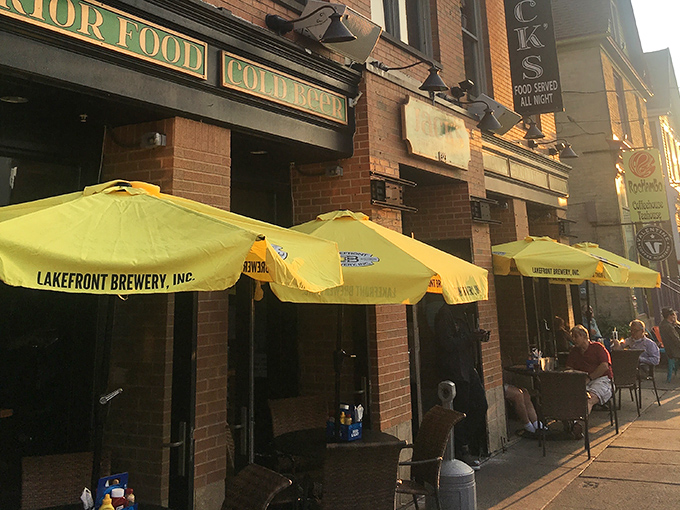 Sun-dappled sidewalk seating under Lakefront Brewery umbrellas – Milwaukee's version of al fresco dining with a side of people-watching.