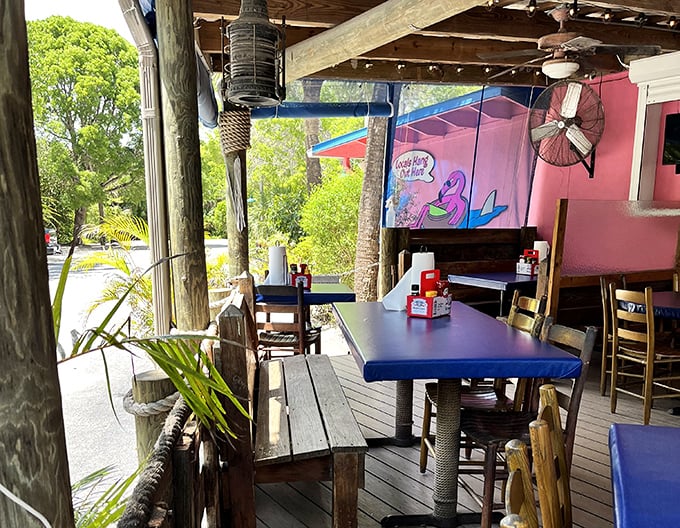 The outdoor patio—where island breezes enhance every bite. These wooden tables have hosted countless sunset dinners and midday escapes.