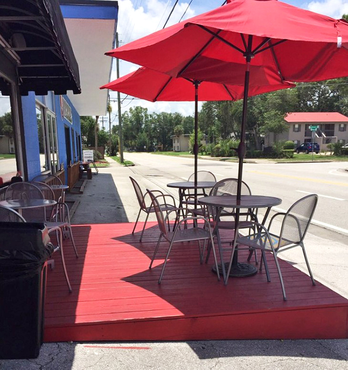 Outdoor seating under bright red umbrellas – because Florida sunshine and great sandwiches were made for each other.