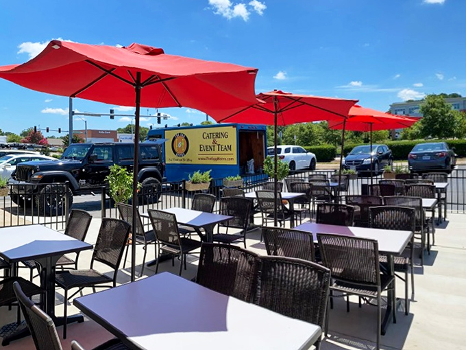 Outdoor seating under cherry-red umbrellas—because vitamin D and breakfast were always meant to be together.