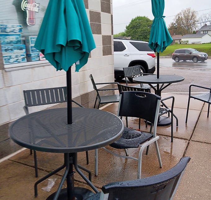 Even rainy days can't dampen the diner experience when there's outdoor seating. Those teal umbrellas match the iconic fin—no design detail overlooked.