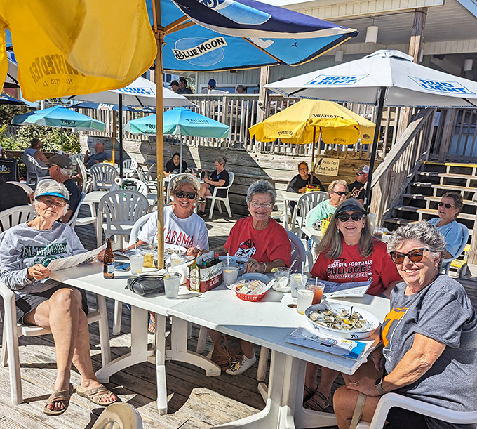 Umbrellas providing shade for sun-kissed diners. These folks aren't just eating lunch—they're collecting stories to make their northern friends jealous.