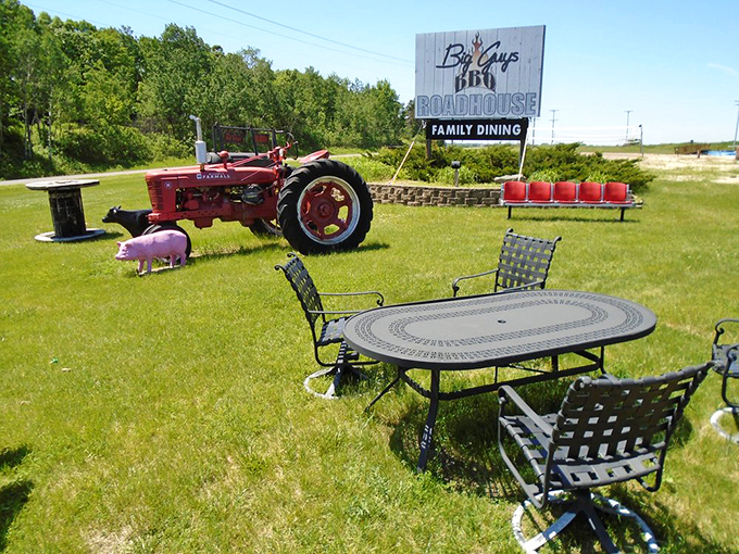 The outdoor setting combines farm charm with dining practicality. That pink pig statue knows what happens inside, yet still smiles—now that's confidence.