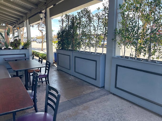 Outdoor seating that strikes the perfect balance between people-watching and plant-sheltered privacy for your dining pleasure.