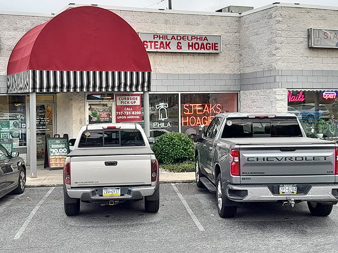 The parking lot view—where anticipation builds as you pull in, knowing sandwich nirvana awaits just beyond that distinctive red awning.