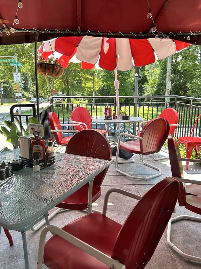The patio's cheerful red chairs and striped umbrellas create an outdoor oasis that feels like the best backyard party in town – minus the cleanup.