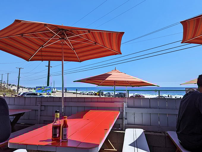 Umbrellas provide shade while you feast, but nothing overshadows the star of the show – that magnificent ocean view and the food it inspires.