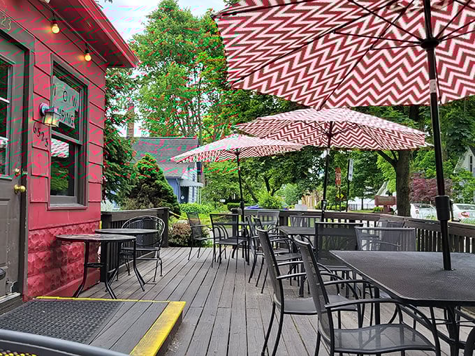Red and white umbrellas create a cheerful oasis on the deck. Summer dining perfection just steps from the Monon Trail.