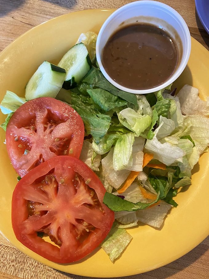 Even the side salad gets respect here—fresh, simple, and honest. Like that friend who tells you the truth about your haircut.