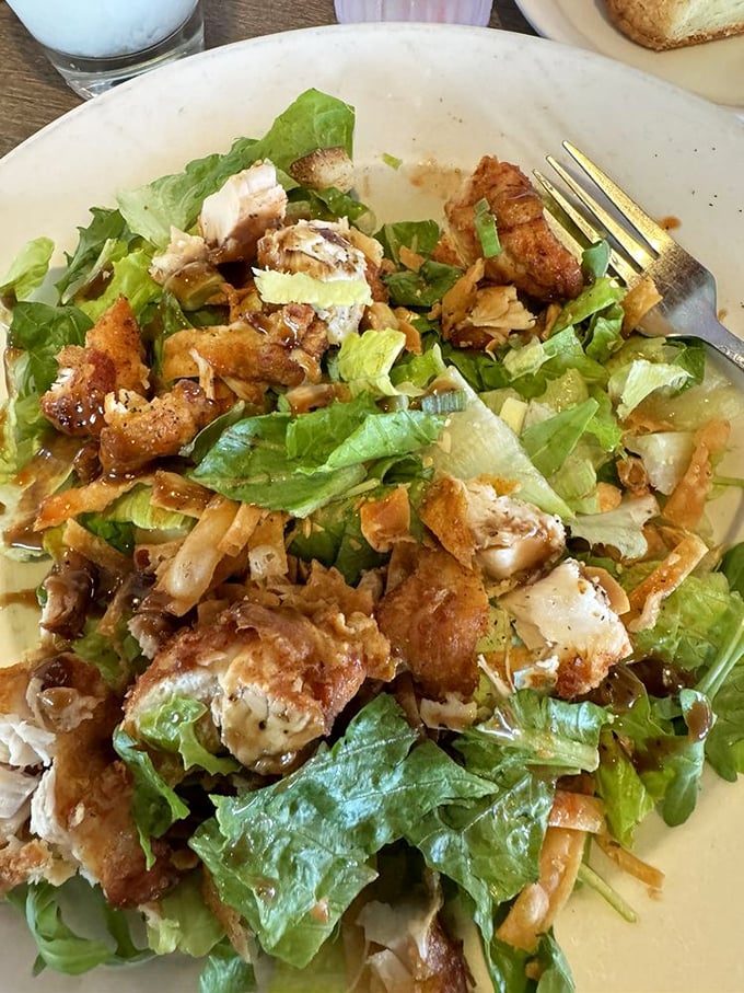 This isn't a salad for people on diets—it's a salad for people who understand that crispy chicken and fresh greens create a textural symphony worth every forkful.