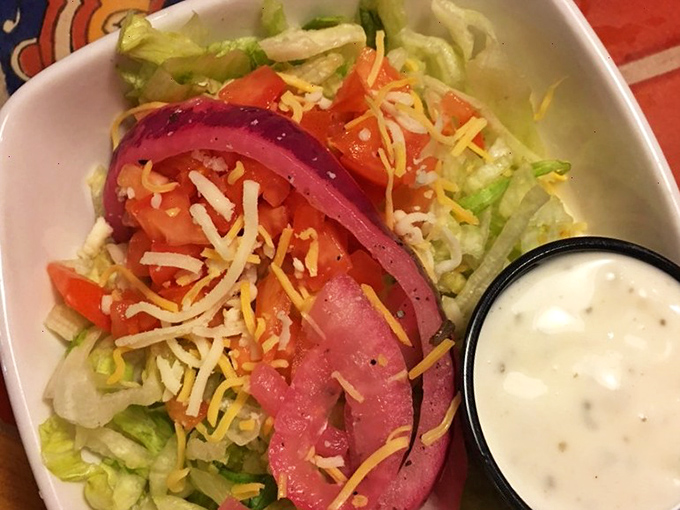 A salad that doesn't apologize for being healthy—it's too busy showing off those vibrant colors and fresh ingredients. That red onion is wearing its Sunday best. 