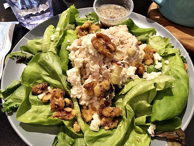 A salad that's having an identity crisis as a feast—crisp greens supporting a generous helping of chicken salad, walnuts, and feta in perfect harmony.