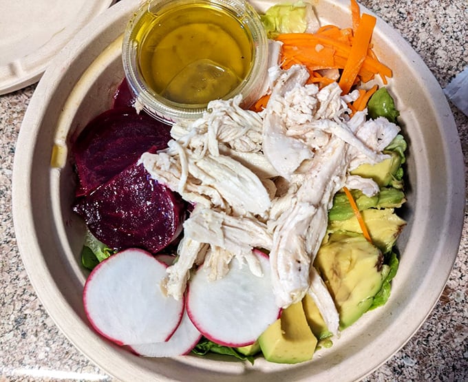 A bowl where health meets happiness – vibrant beets, creamy avocado, and protein dance together in a salad that makes virtue taste suspiciously like indulgence.