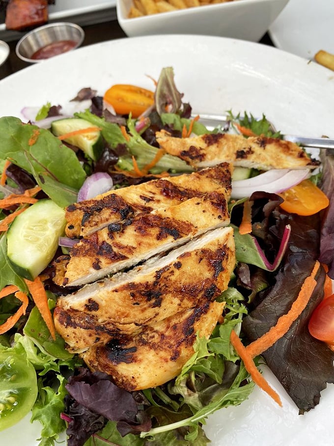 Even the salads get the star treatment—grilled chicken perched atop fresh greens proves barbecue joints can do balance too. 