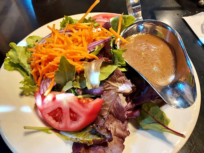A garden-fresh salad that doesn't apologize for being healthy—crisp greens, vibrant carrots, and that house dressing you'll wish came by the bottle.