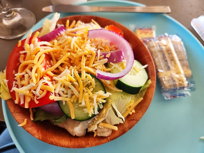 A salad that doesn't apologize for being healthy – vibrant veggies and cheese in a wooden bowl that somehow makes everything taste more authentic.