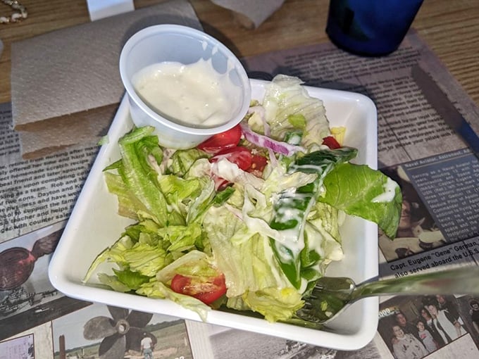 A simple house salad that knows its purpose – to provide the lightest counterpoint to the seafood feast that's about to unfold.