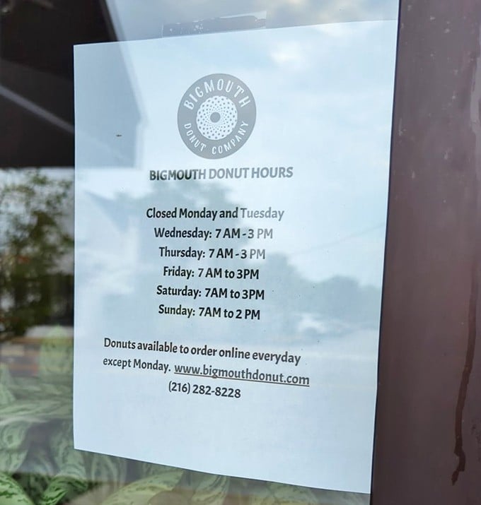 The hours posted clearly—because knowing when you can get your next donut fix is information more crucial than the weather forecast.