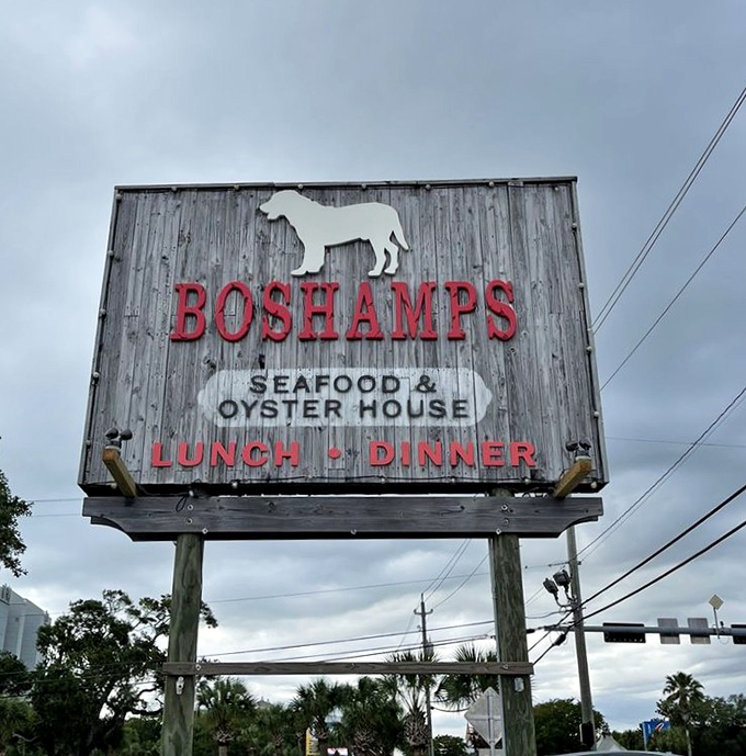 The sign says it all—seafood, oysters, and that distinctive dog silhouette that's become Boshamps' calling card throughout Destin.