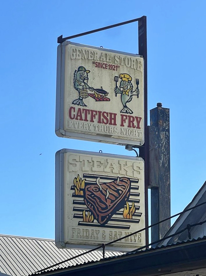 Twin signs promising catfish and steaks – like a beacon calling hungry travelers home since 1921.