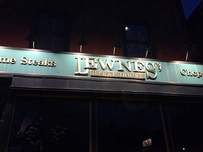 The illuminated sign glows like a lighthouse for hungry sailors. At night, it's less "restaurant signage" and more "beacon of carnivorous hope."