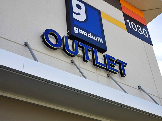 The blue Goodwill smile logo—a beacon for bargain hunters. This sign promises adventures in affordable retail therapy unlike any other.