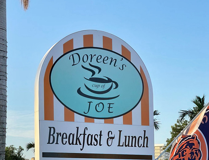 A sign that doesn't just mark a location—it promises a morning transformation. Those orange stripes are basically runway lights guiding you to breakfast bliss.