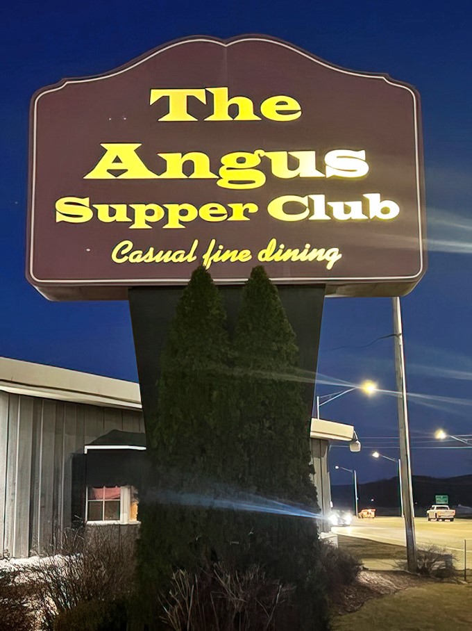 The sign against twilight sky announces "Casual fine dining"—Wisconsin's way of saying "Come as you are, eat like royalty."