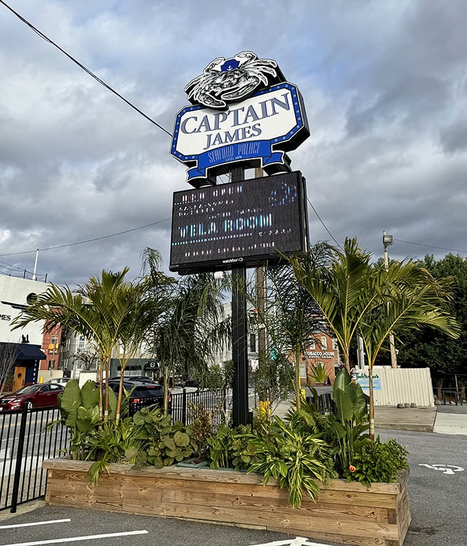 The Captain James sign stands tall like a maritime lighthouse, guiding hungry travelers toward crabby salvation with blue-lit authority.