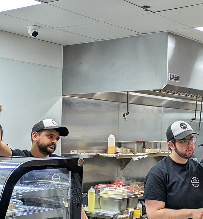 The sandwich artisans at work. Not all heroes wear capes—some wear caps and create edible masterpieces on a hot griddle.