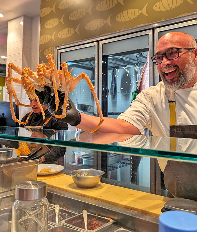 That moment when a chef proudly displays a massive king crab leg—it's like Excalibur, but tastier and from the sea.