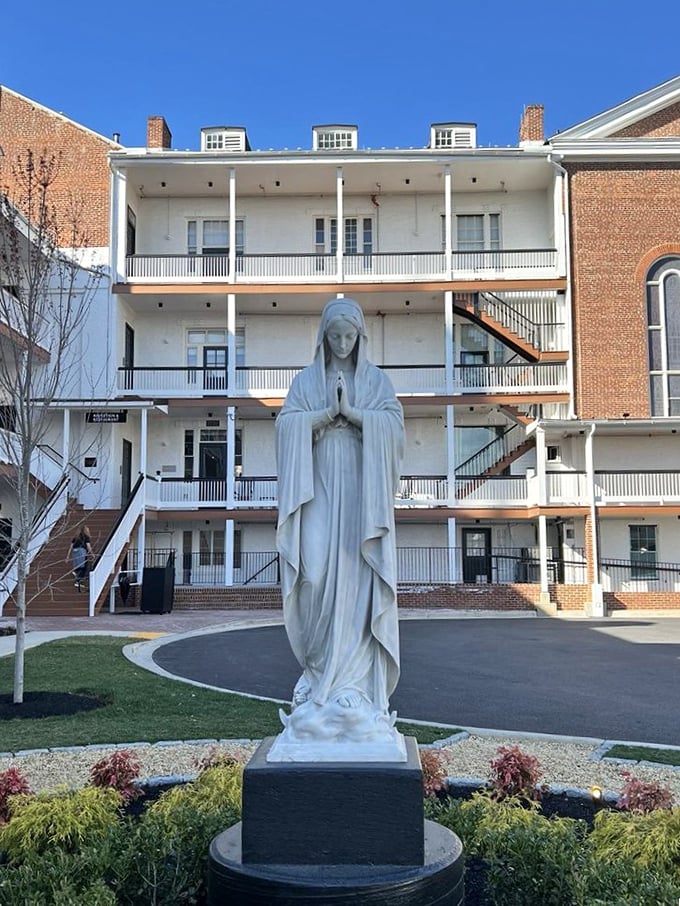 A serene statue watches over the courtyard, blessing all who enter this temple of exceptional cuisine.