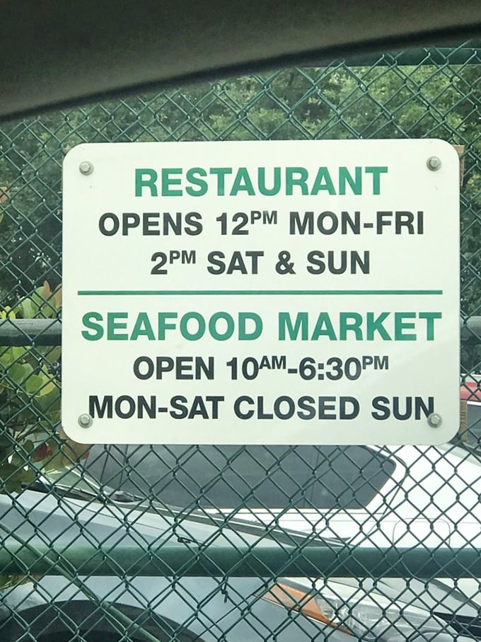 Even the hours sign tells a story: a restaurant that follows its own schedule, operating on what can only be called "seafood time."