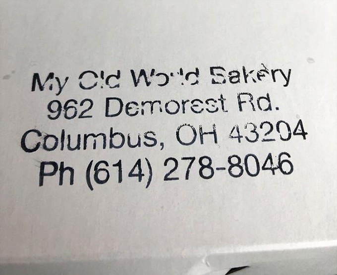 The bakery's contact information stamped with the same straightforward approach they bring to their pastries—no frills, just the facts.