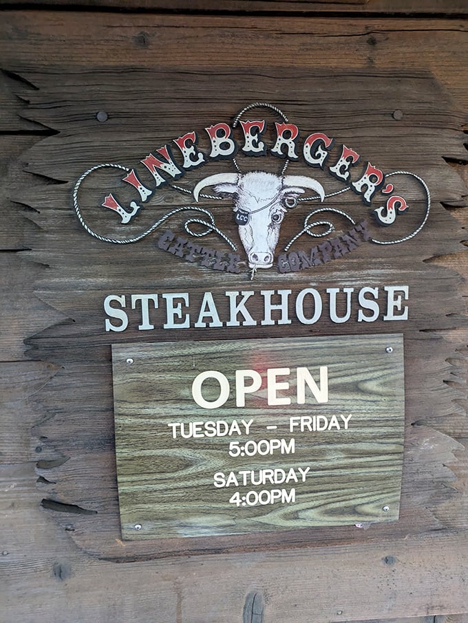 Operating hours posted on weathered wood – information that's worth committing to memory if you value exceptional beef.
