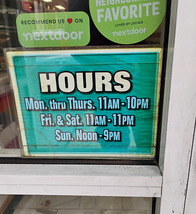 The hours sign that should be memorized by all local food lovers. Open seven days a week because great pizza waits for no one.