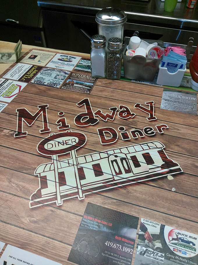 The table setting tells the whole story: salt, pepper, sugar packets, and local business cards—the essential elements of diner ecosystem.