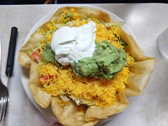 This taco salad bowl doesn't just hold ingredients – it cradles them in a crispy shell throne topped with a crown of sour cream.