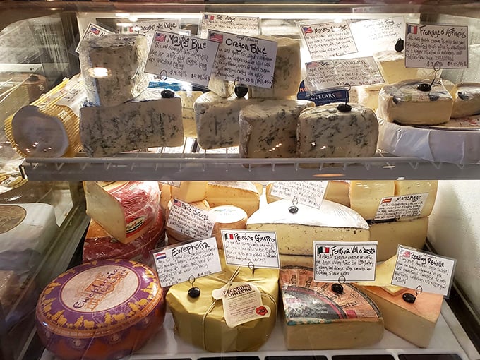 The cheese case—where dreams are born and diets go to die. Each handwritten card tells a story of flavor that began oceans away.