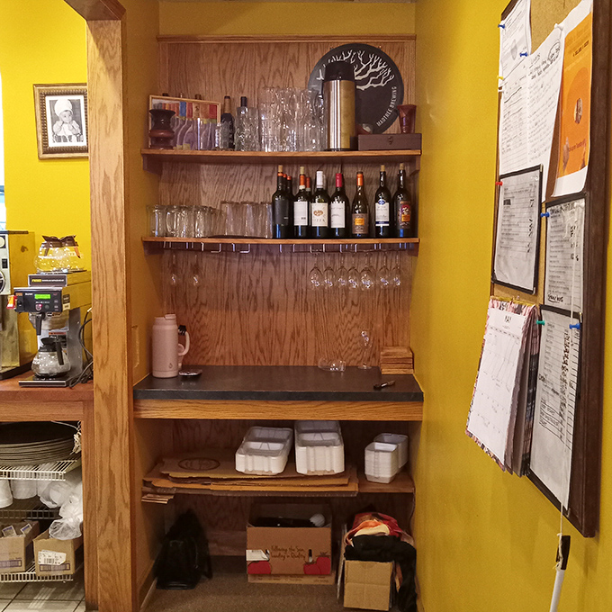 This modest wine display isn't trying to impress you with labels—it's quietly confident that what's inside those bottles will do all the talking.