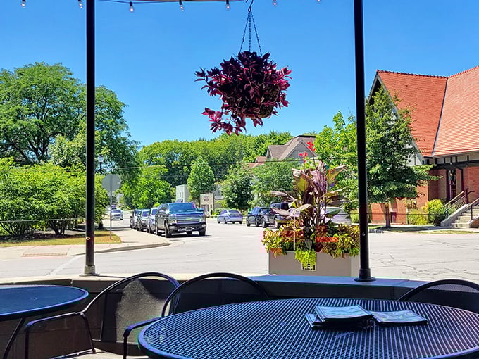 The patio view offers a slice of small-town Indiana life with your meal. Hanging plants and sunshine make everything taste better—scientific fact.