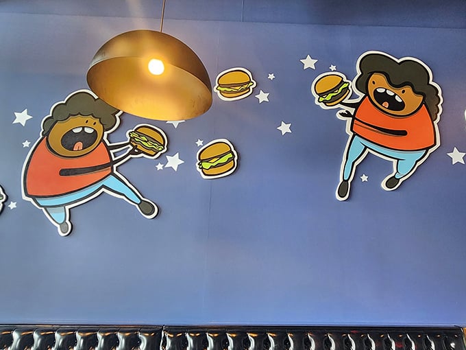 These whimsical burger-loving characters on the wall perfectly capture how you'll feel after your first bite – floating in a state of burger euphoria.