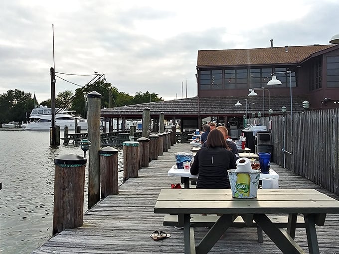 Waterfront dining doesn't get more authentic than this—wooden picnic tables perched on a dock where your meal practically waves to the water it came from.